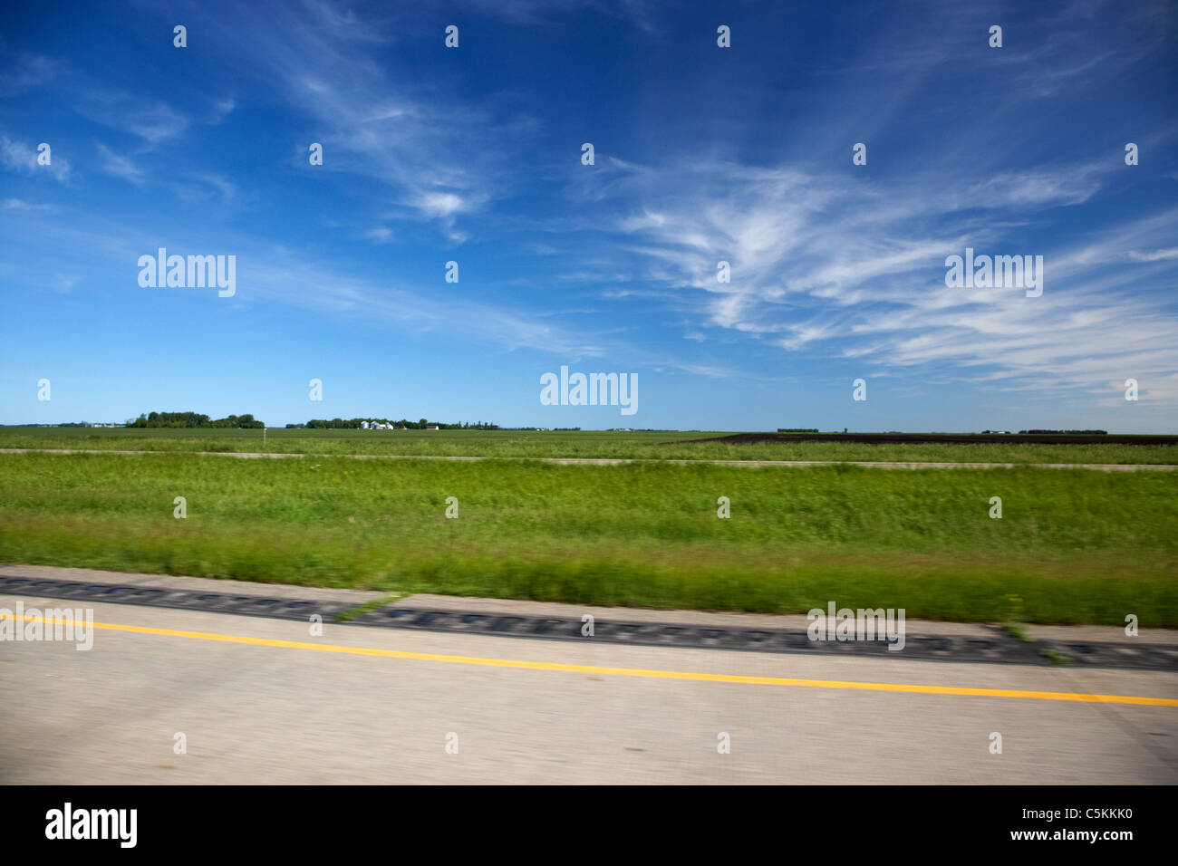 driving at speed along highway through the prairies of north dakota on ...
