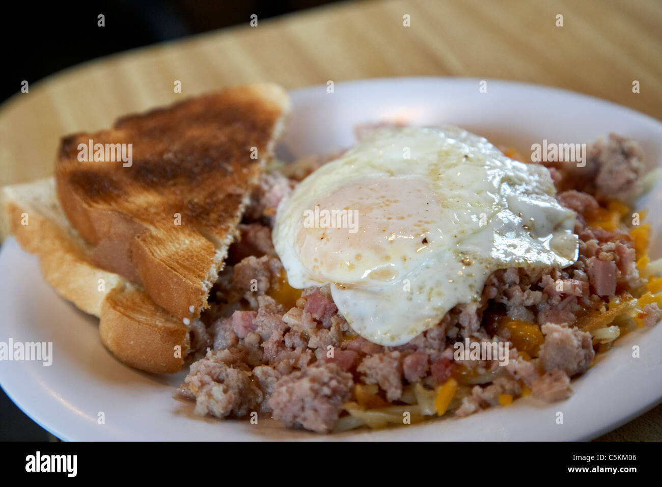 half meat skillet with egg and toast in a diner in the usa Stock Photo ...