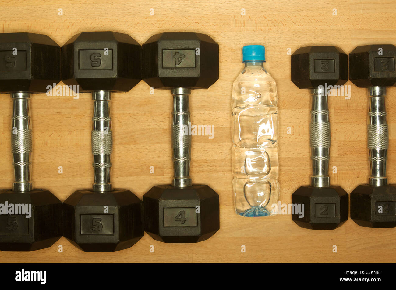 Gym weights on the floor at a gym Stock Photo - Alamy