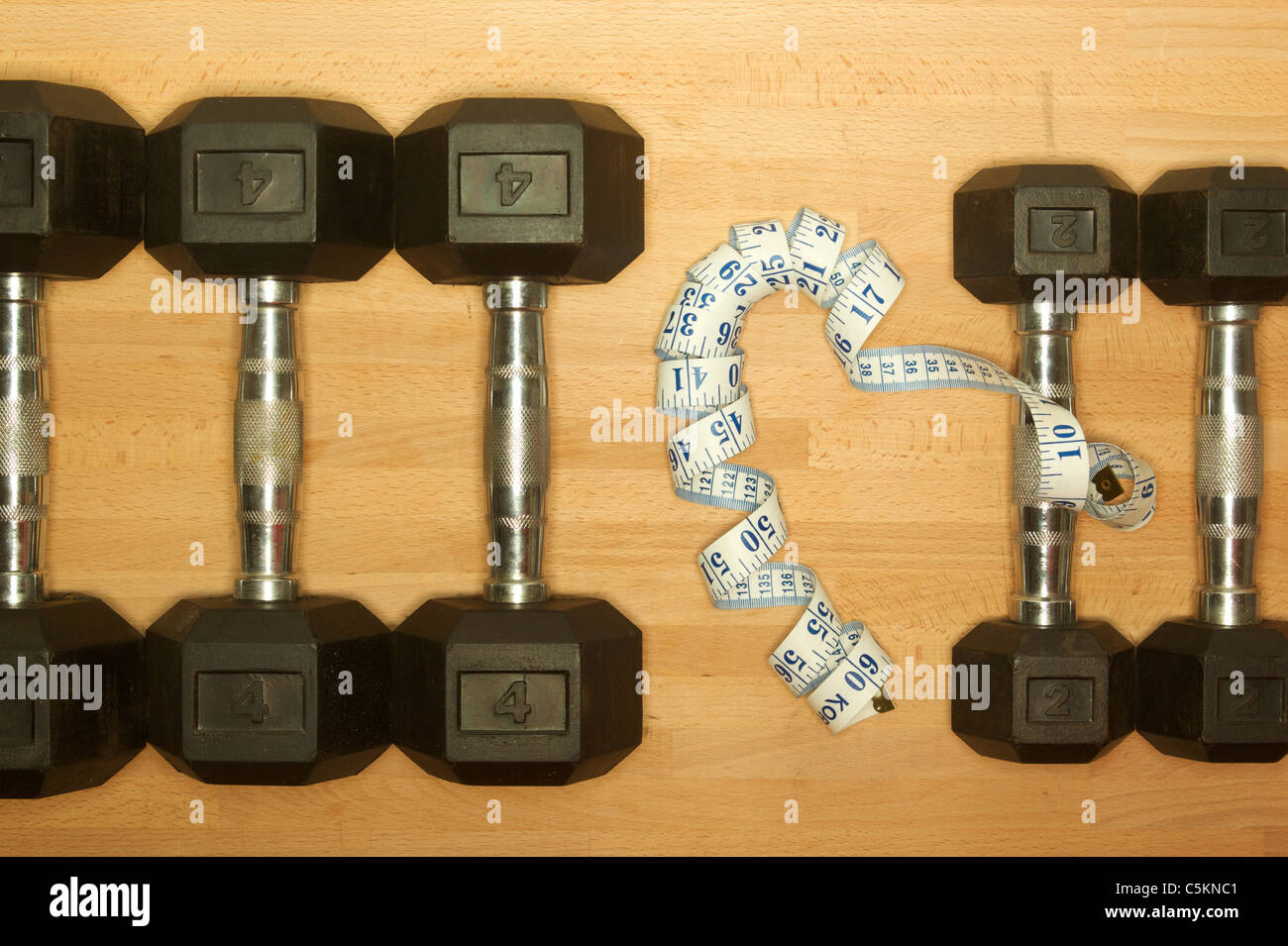 Gym weights on the floor at a gym Stock Photo - Alamy