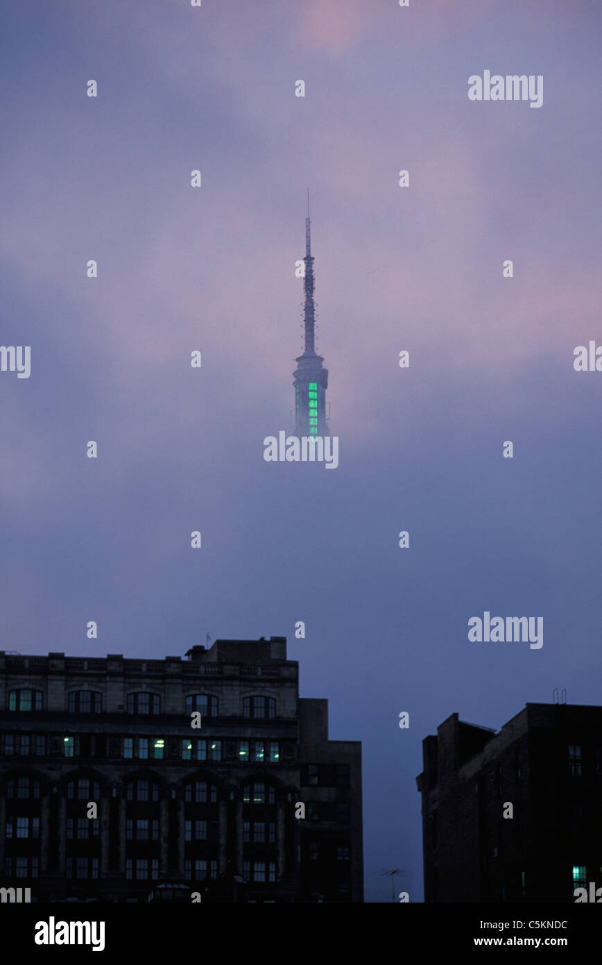 Empire state building tower, partially obscured by clouds, NYC Stock ...