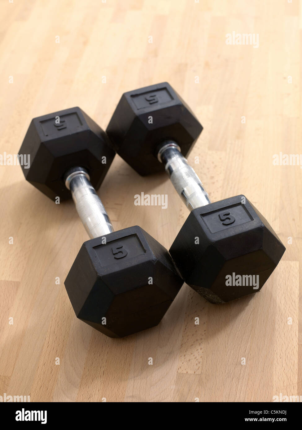 Gym weights on the floor at a gym Stock Photo - Alamy