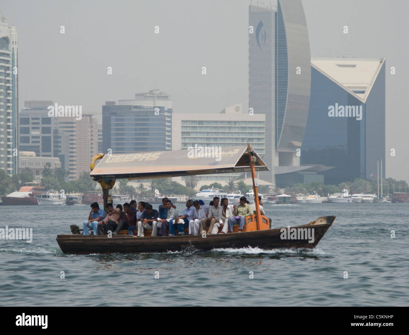 An Abra, a traditional wooden water-taxi boat, crossing The Creek in ...