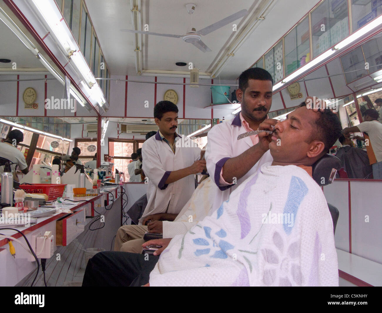 Barber's shop with man being shaved with cutthroat razor, Dubai, United ...
