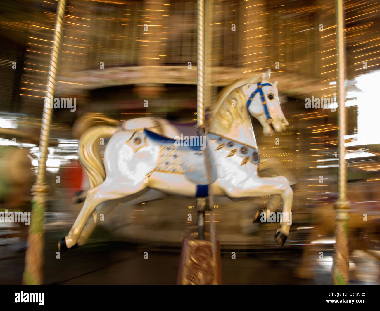 Carousel turning, white horse passing with motion blur, Nice, France ...
