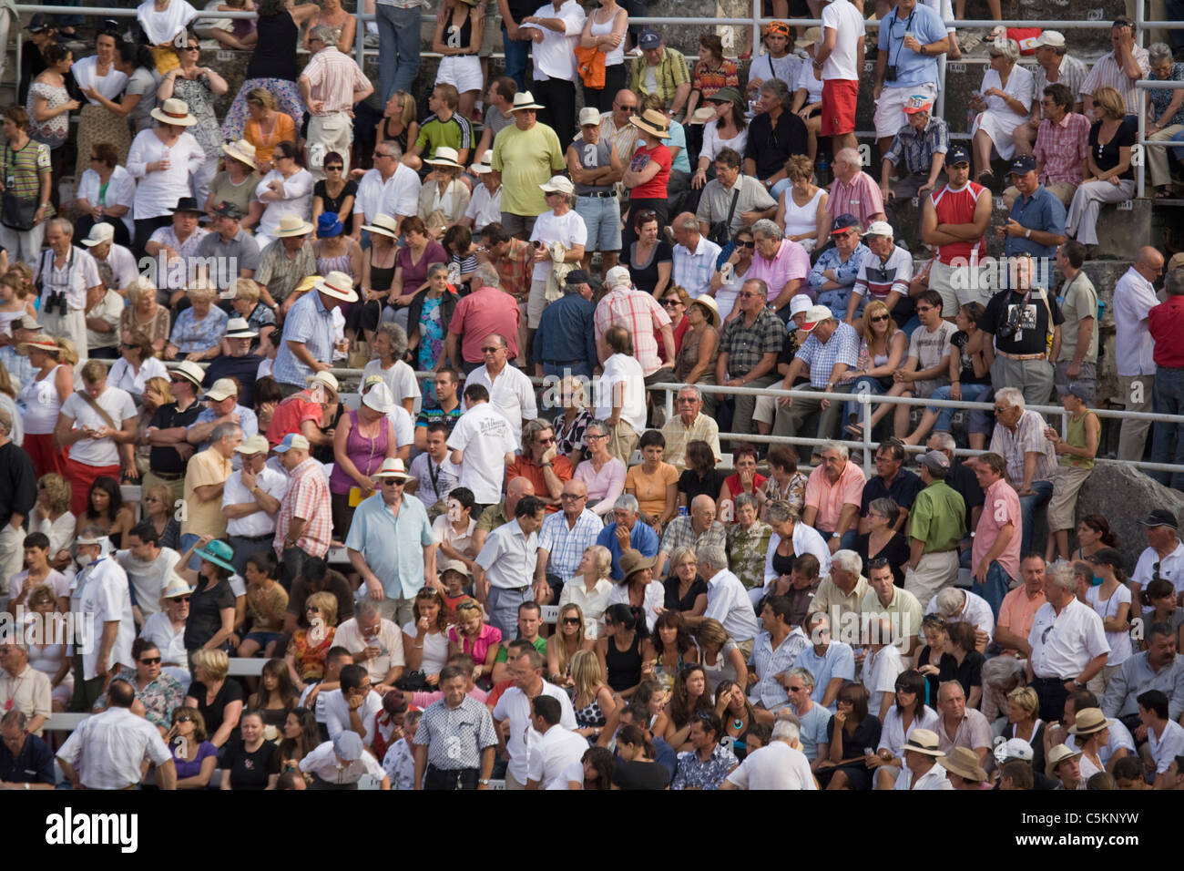 People in the crowd at a bullfight in the Roman Arena, Arles, France ...