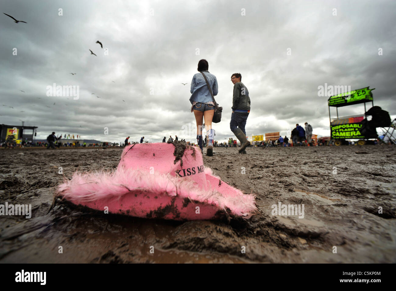 Music fans walk through the mud at music festival Stock Photo - Alamy