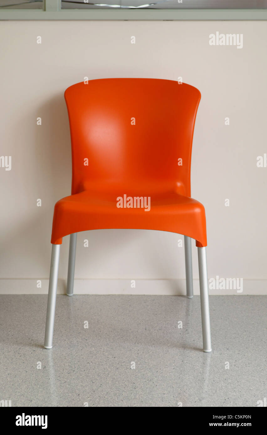 Orange plastic chair in a company reception waiting area Stock Photo ...