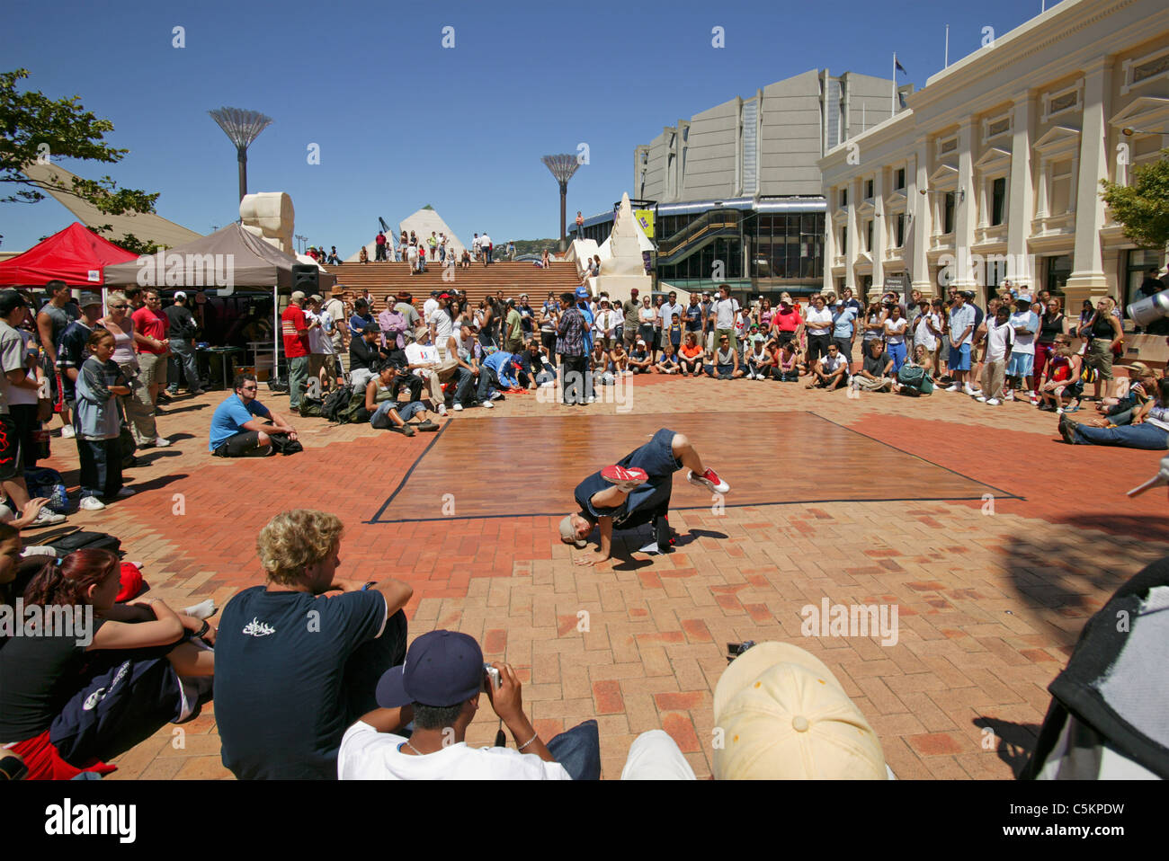 Break dancing competition in Civic Square with a crowd watching a boy ...