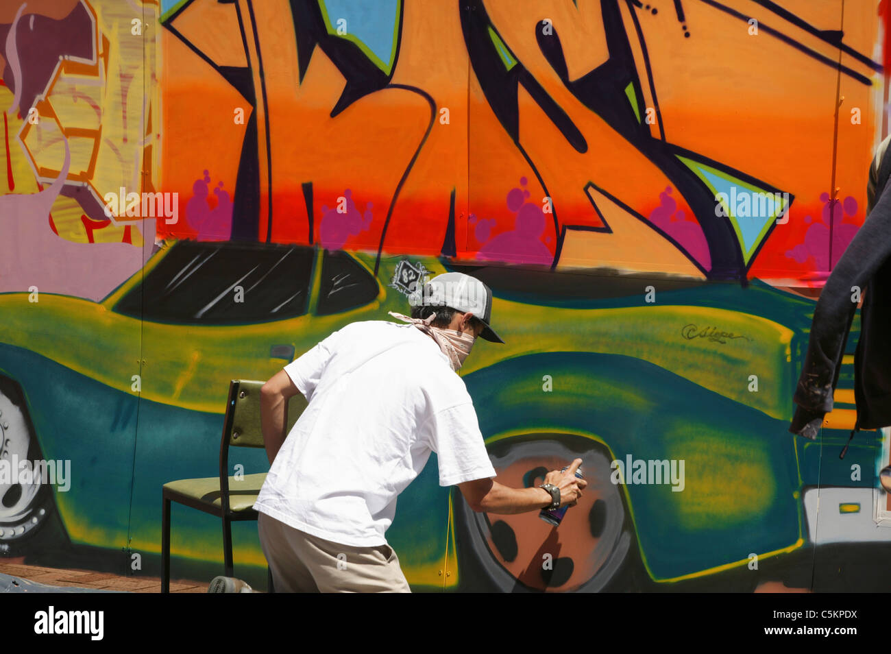 A boy tagging a temporary wall in a graffiti competiton, Civic Square ...