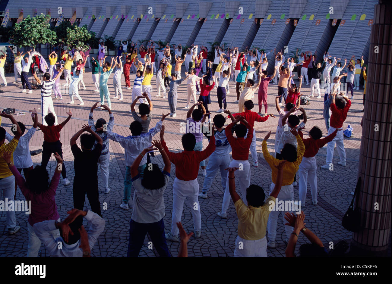 Crowd of people exercising together in open-air, Tsim Sha Tsui, Hong ...