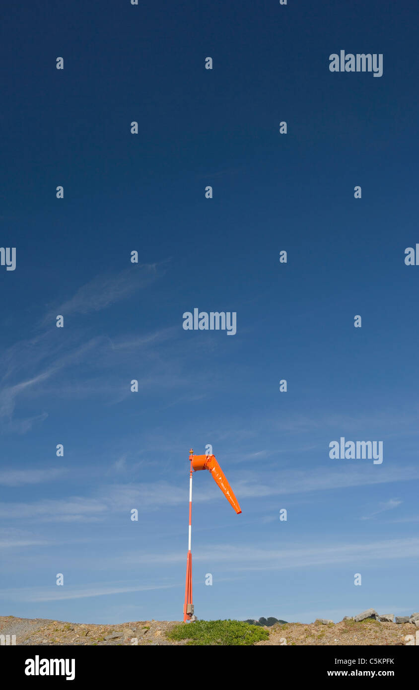 Orange windsock against blue sky with white cirrus clouds, Wellington ...