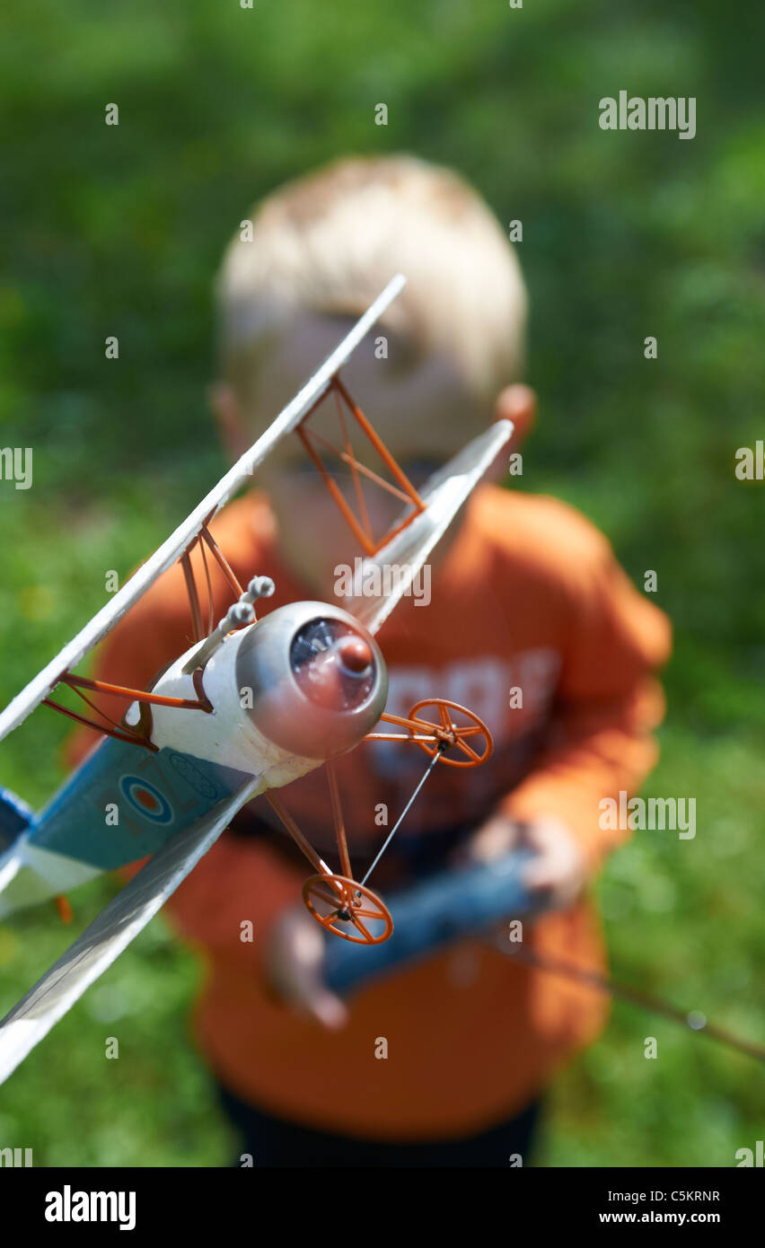 Young blond boy flying a remote controlled plane Stock Photo - Alamy