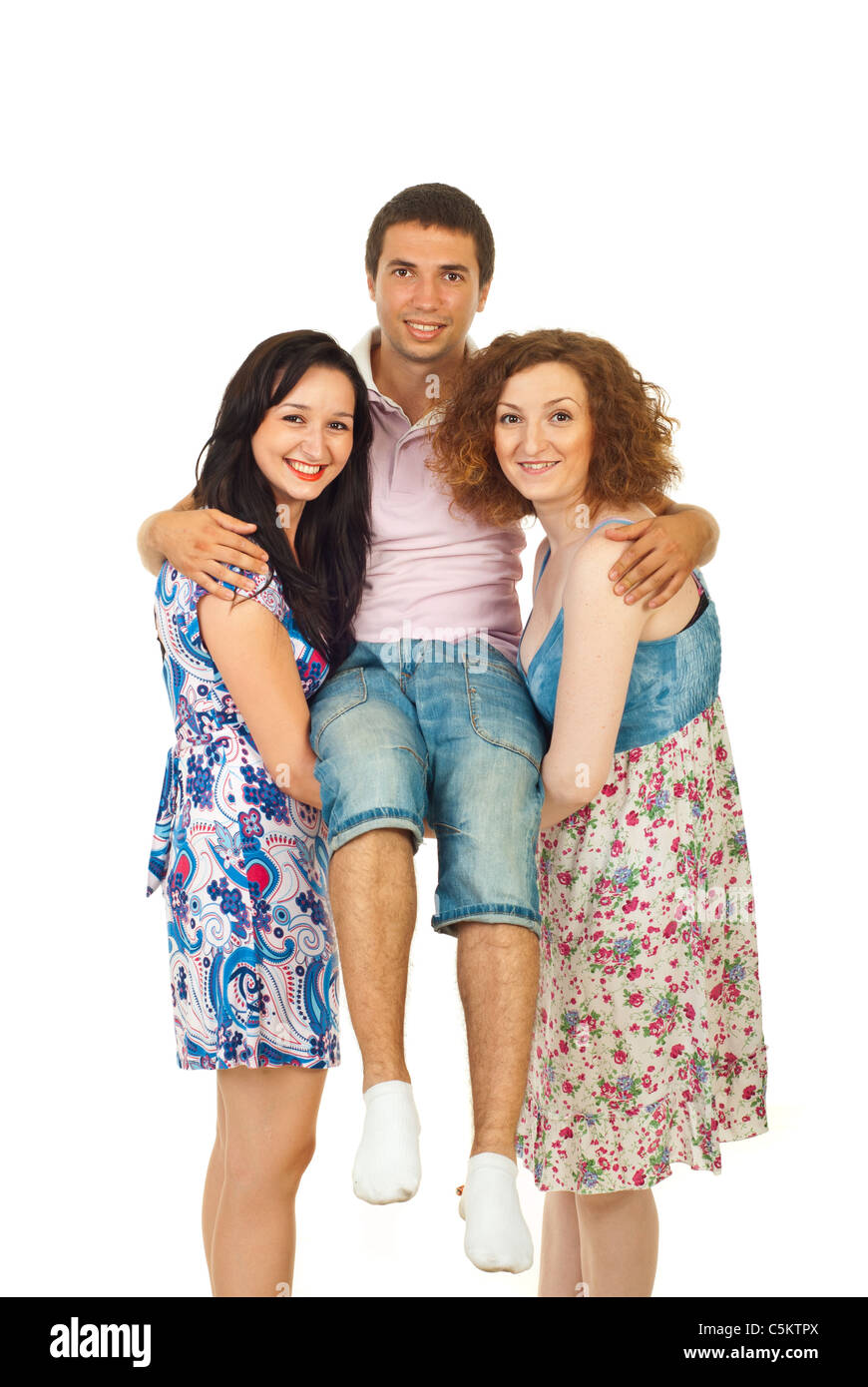 Two happy women carrying a man on their hands isolated on white ...