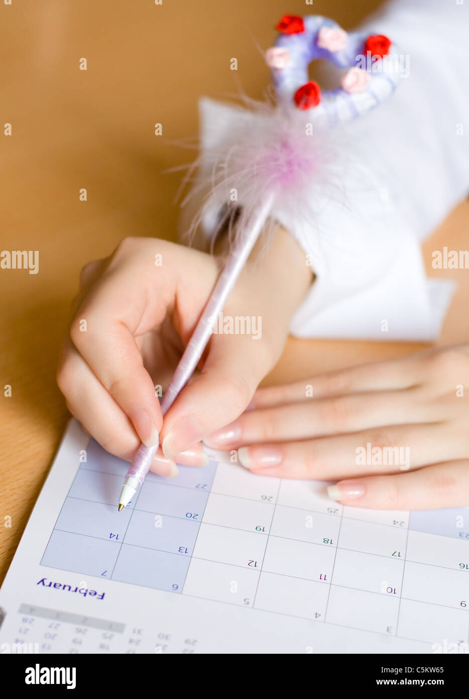Woman's hands with calendar and pen Stock Photo - Alamy