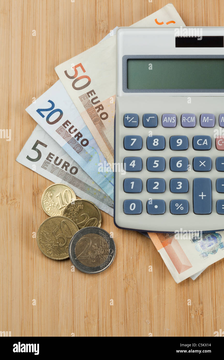 Money and pocket calculator Stock Photo - Alamy