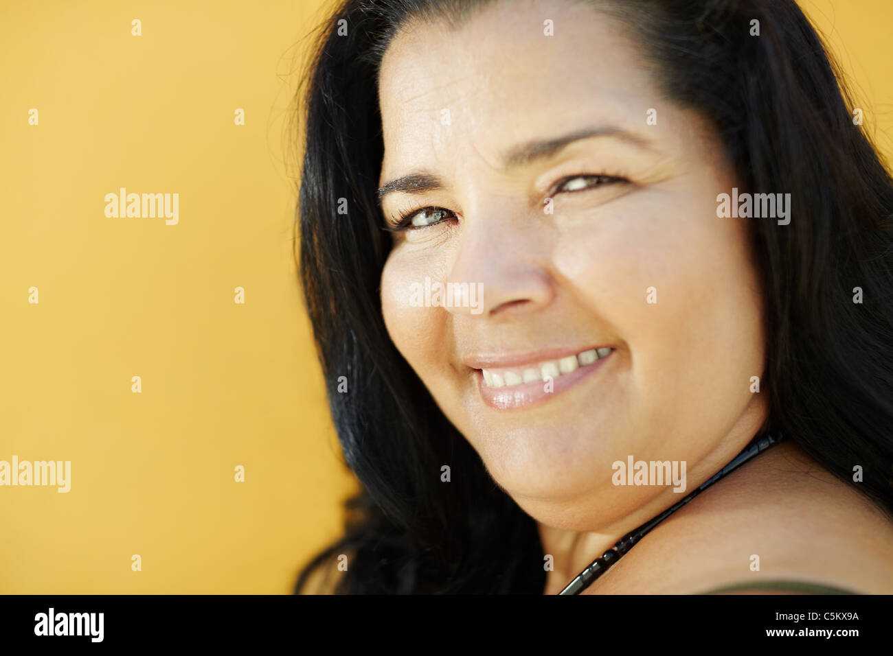 portrait of latin american 50 years old overweight woman smiling on ...