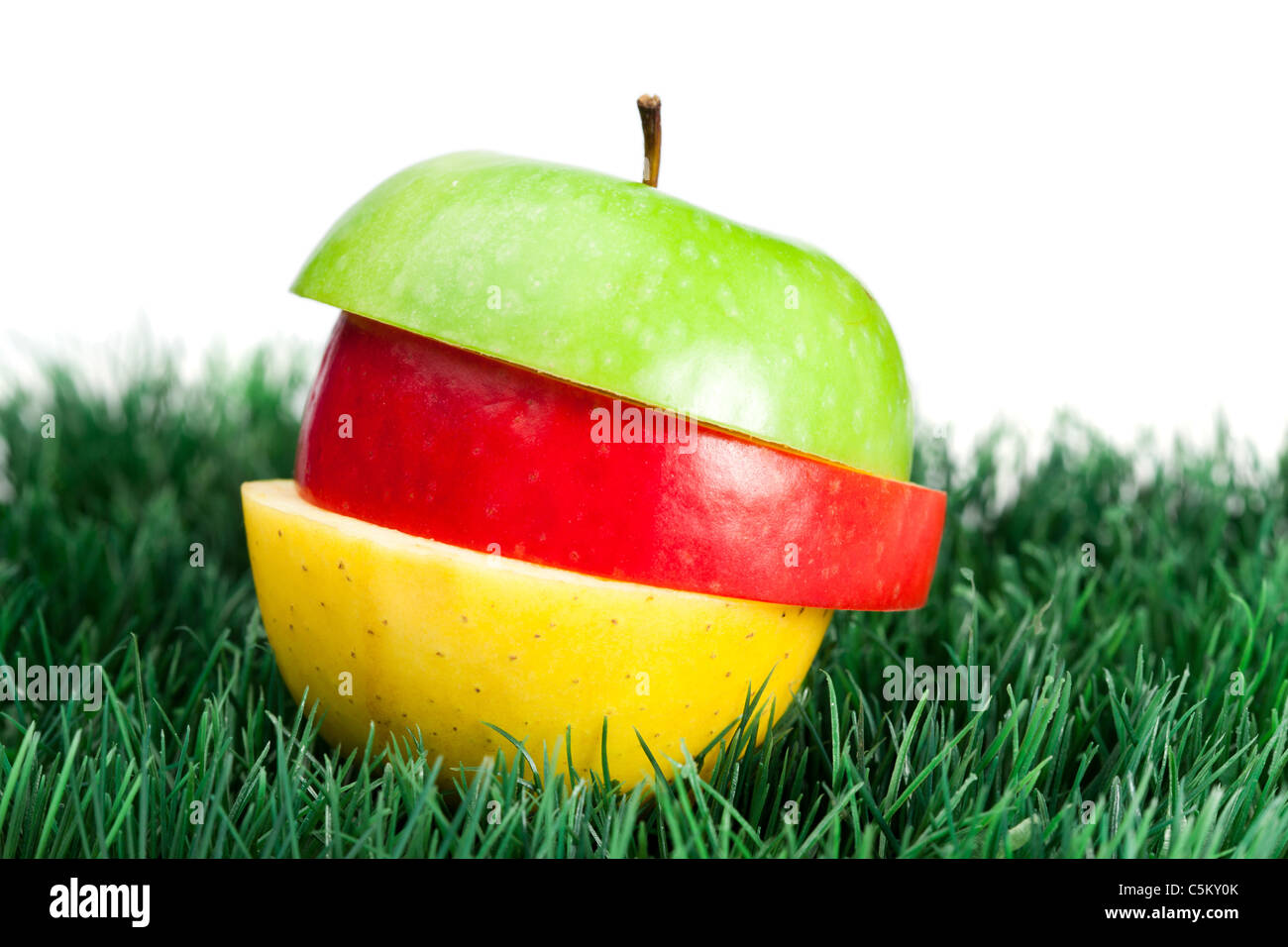 Combination of green, yellow and red apples on grass Stock Photo - Alamy