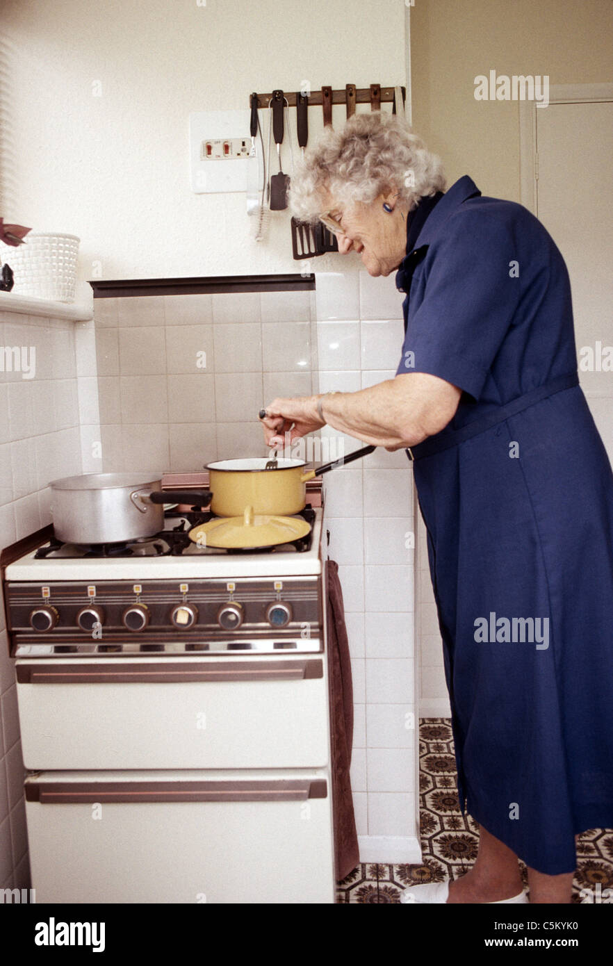 elderly woman cooking dinner on her own Stock Photo - Alamy