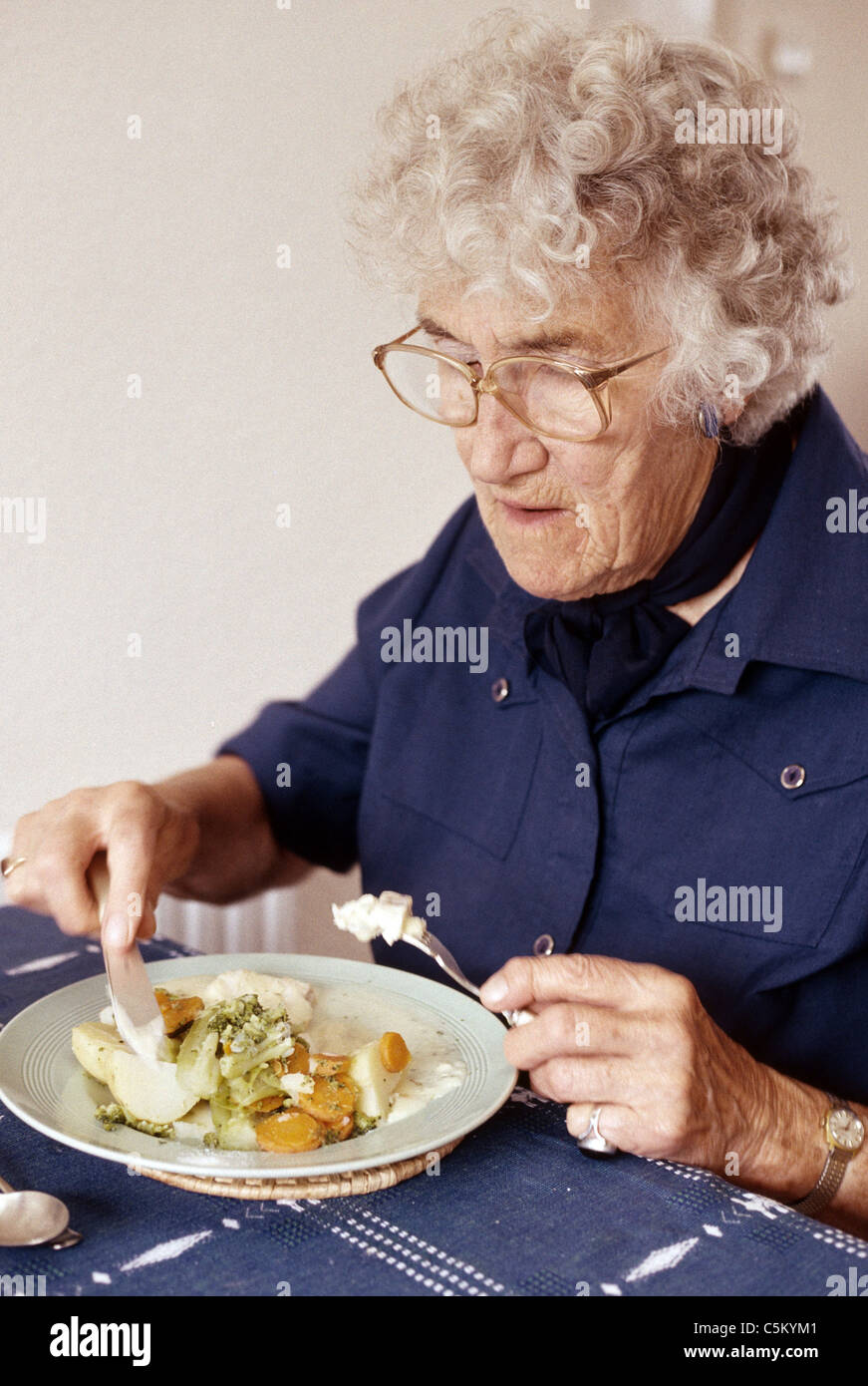elderly woman eating a meal alone Stock Photo - Alamy