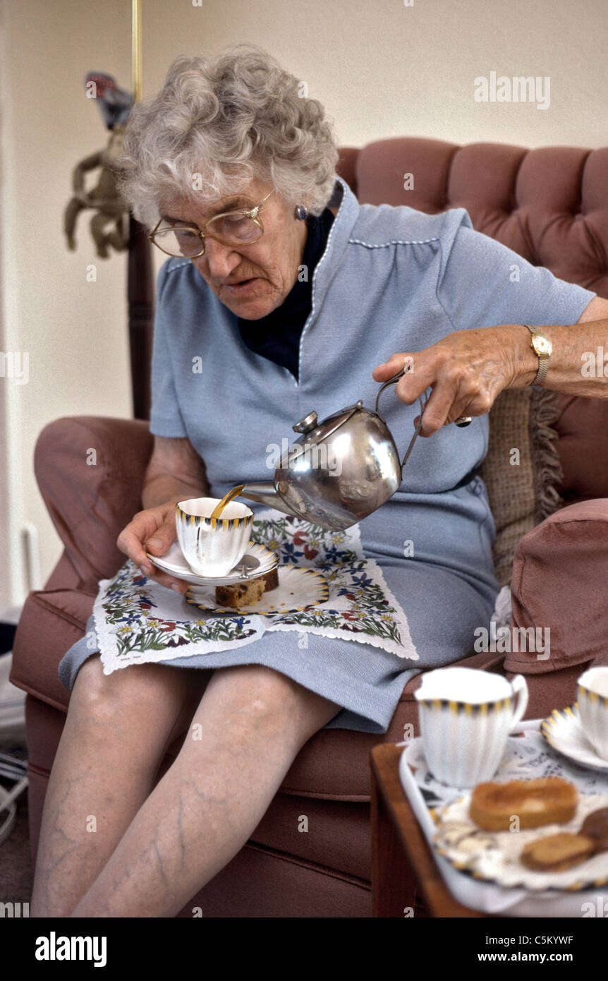 elderly woman serving up tea and cakes at home Stock Photo - Alamy