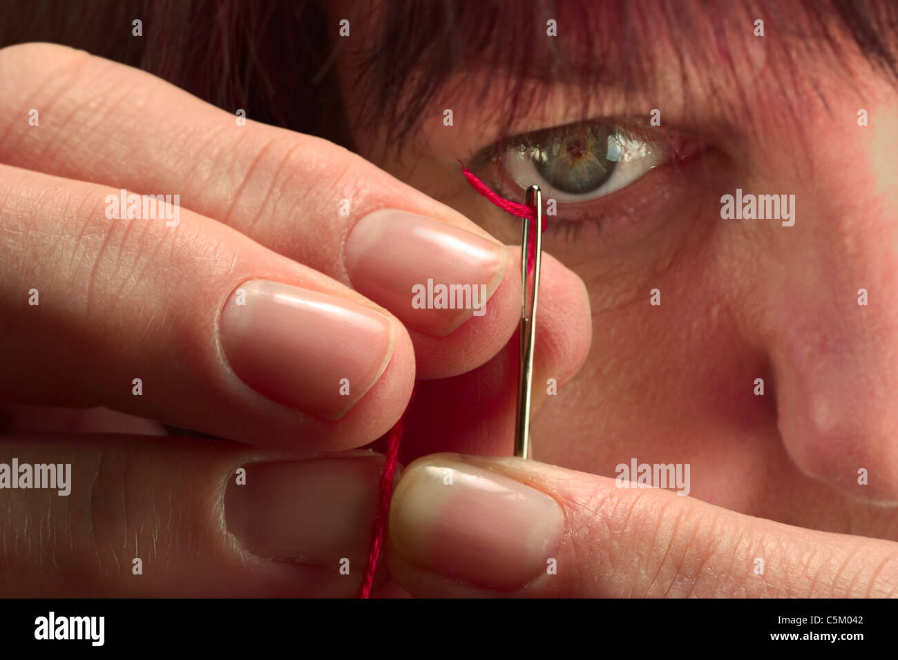 Woman threading a needle hi-res stock photography and images - Alamy