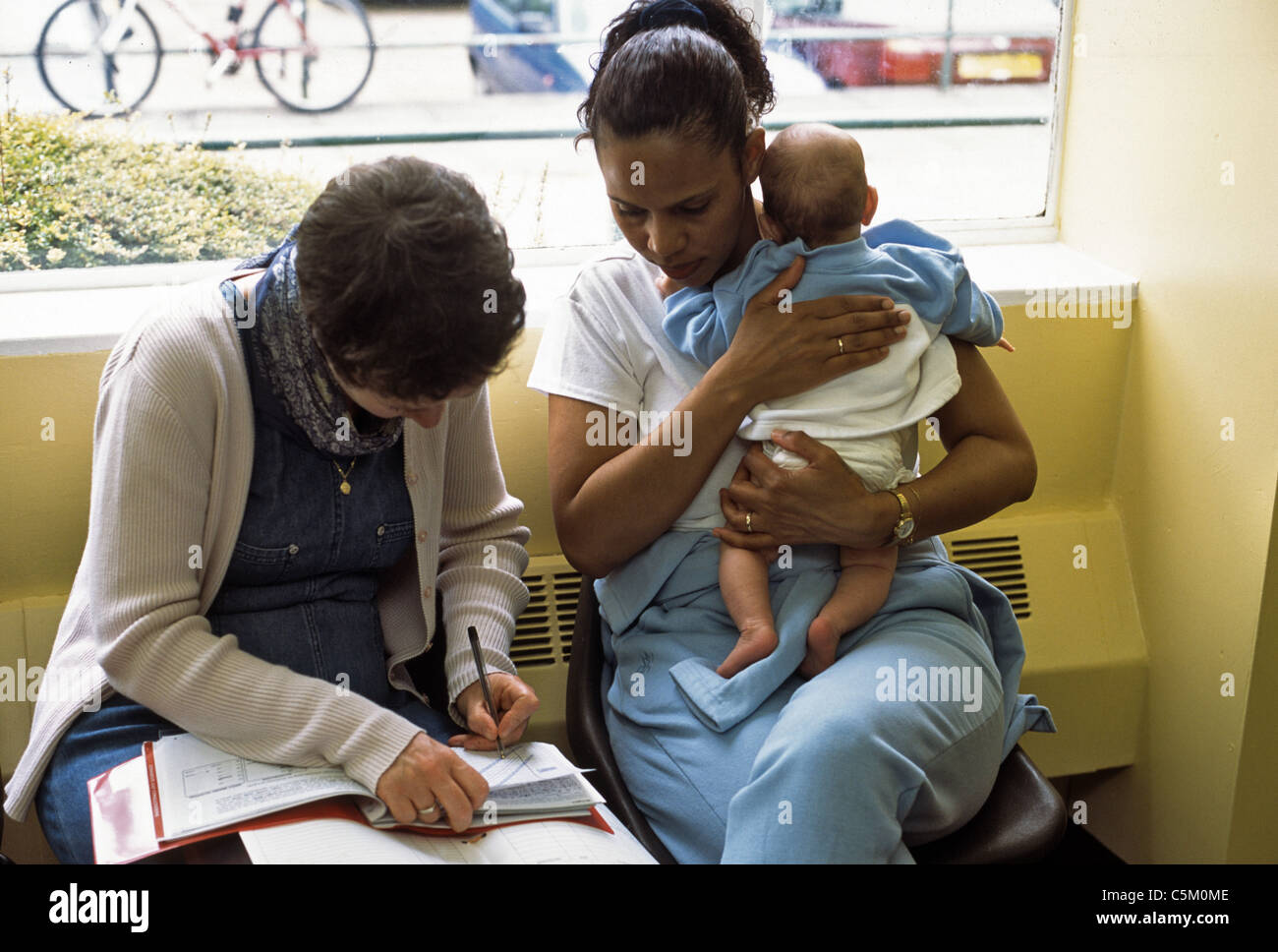 mother and baby visiting midwife at mother and baby clinic Stock Photo ...
