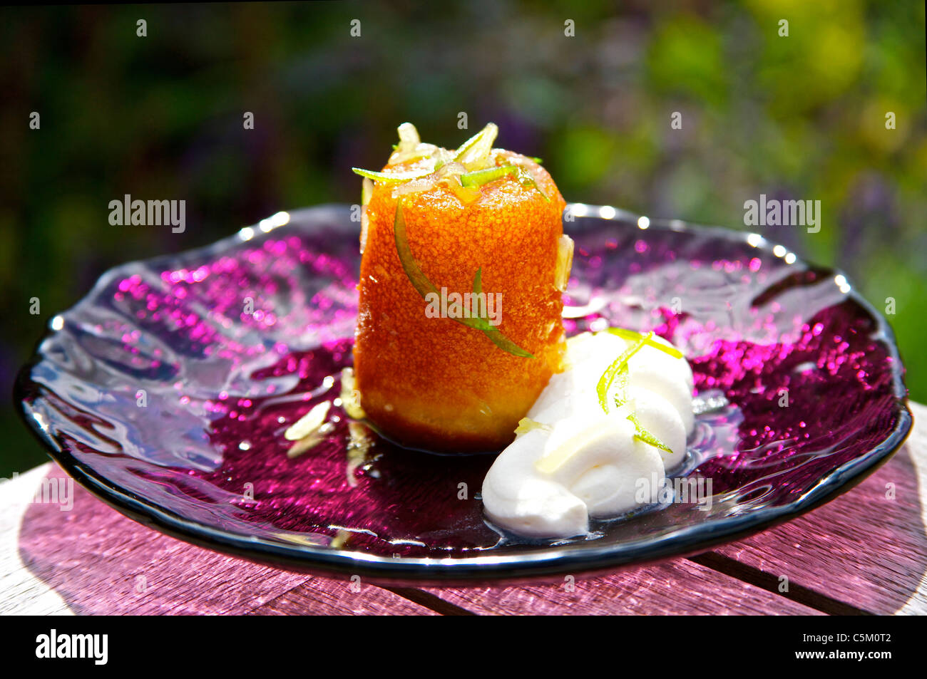 Treacle Sponge and cream on a pink glass plate Stock Photo - Alamy