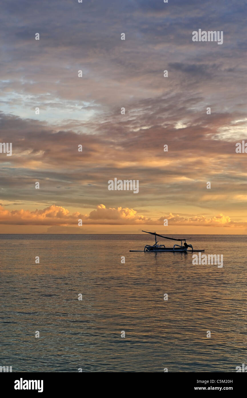 a traditional indonesian jukung boat at sunrise Stock Photo - Alamy