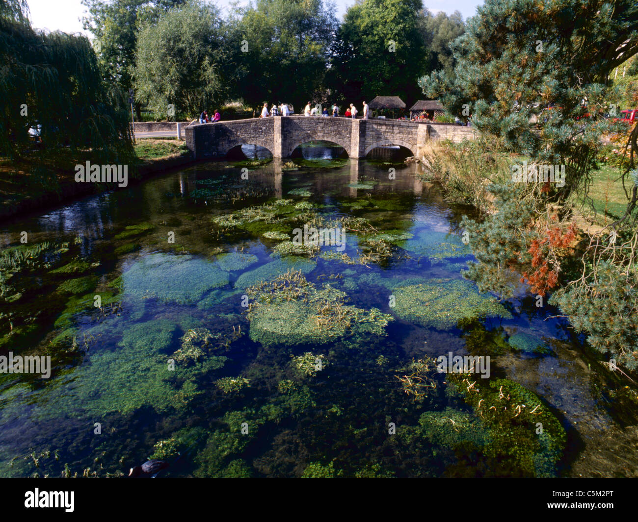The bridge over the River Coln at Bibury crowded with summer visitors ...