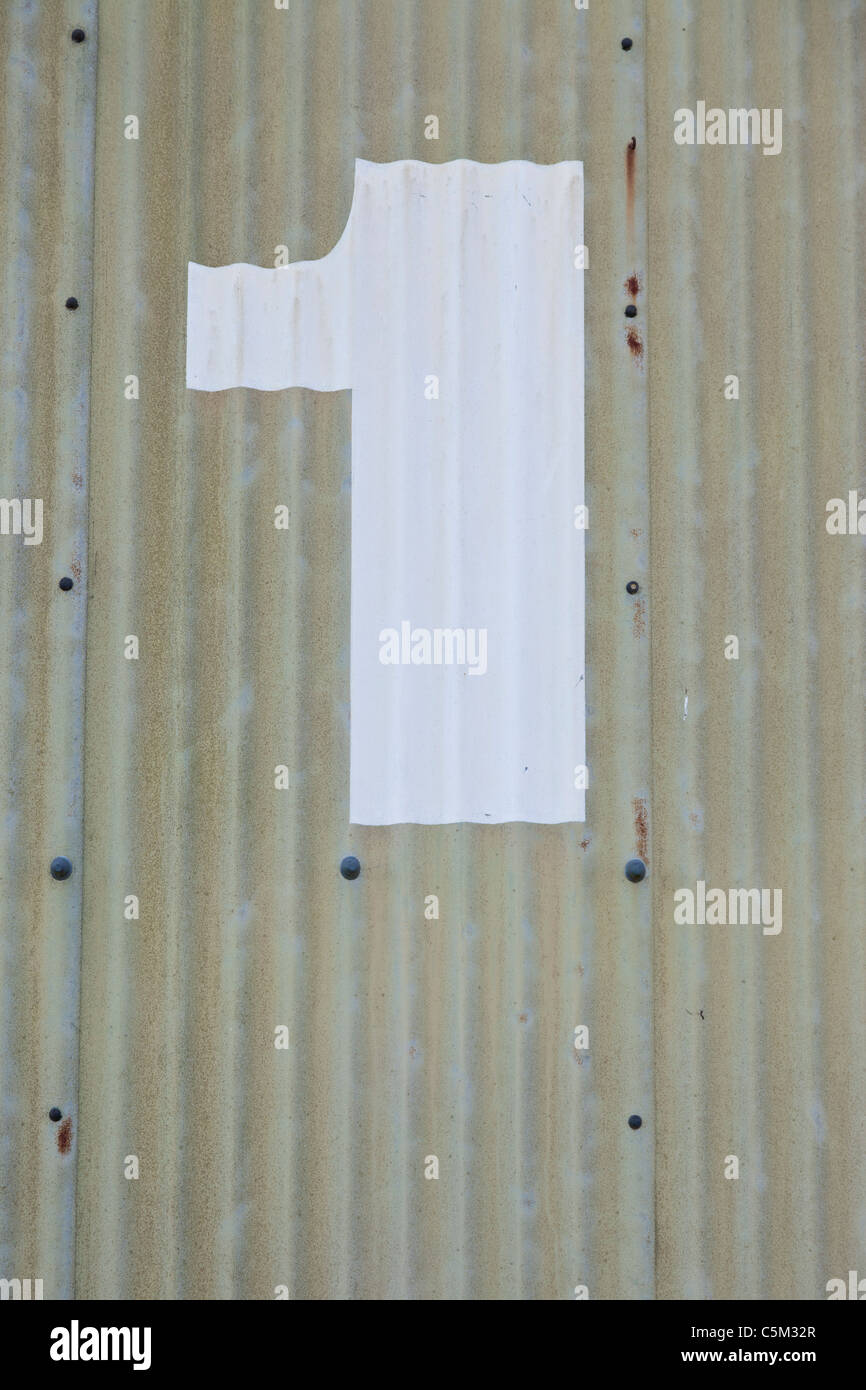 Number 1 painted on corrugated iron building Stock Photo - Alamy