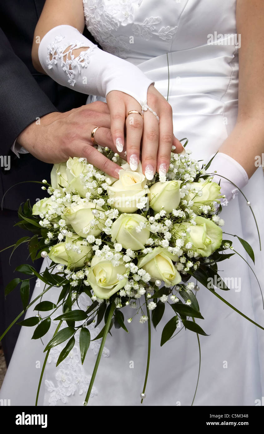 Groom and bride are holding and showing their gold rings, wedding ...