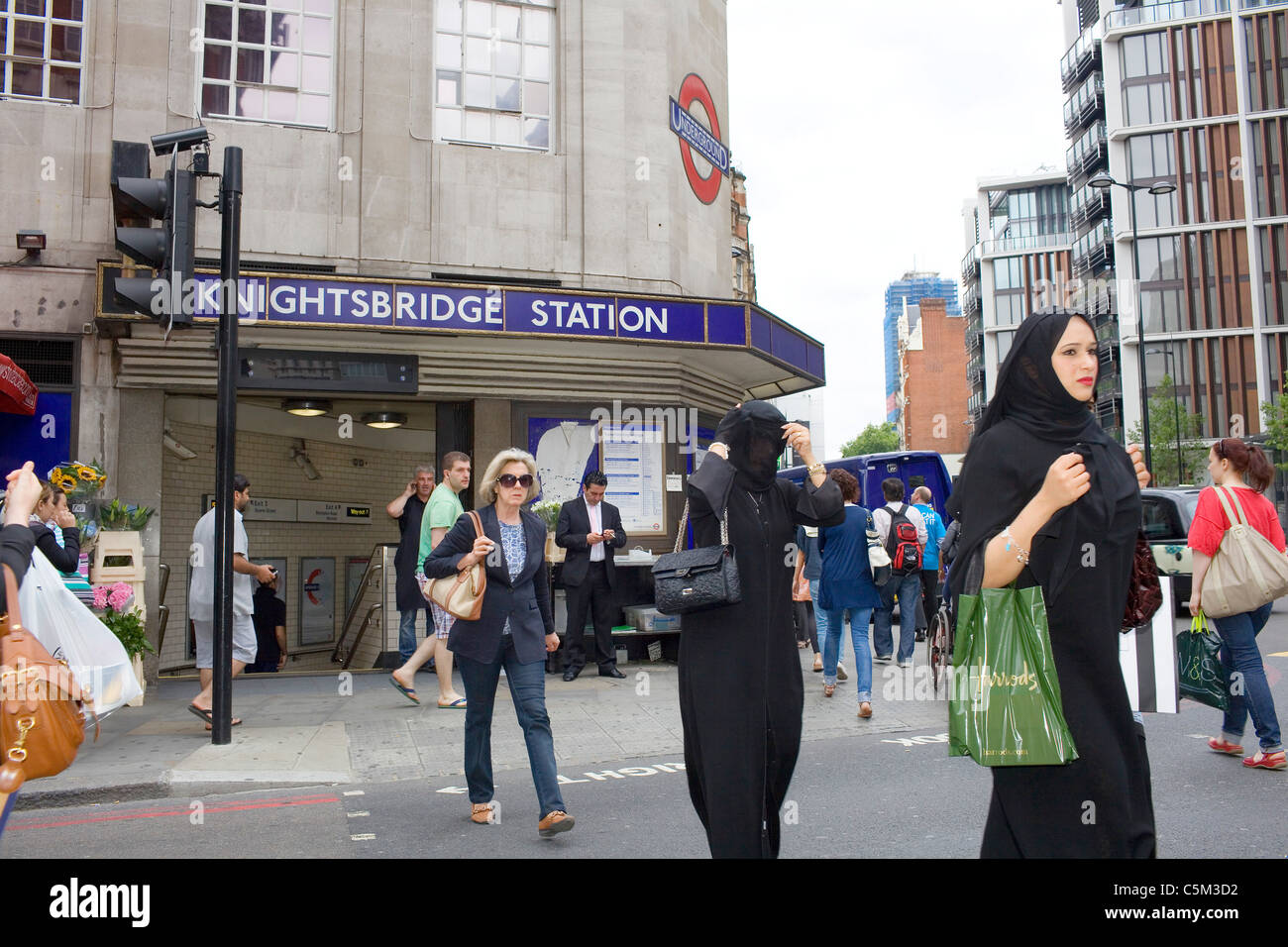 Two Muslim women cross Sloane Street at the Knightsbridge Station end ...