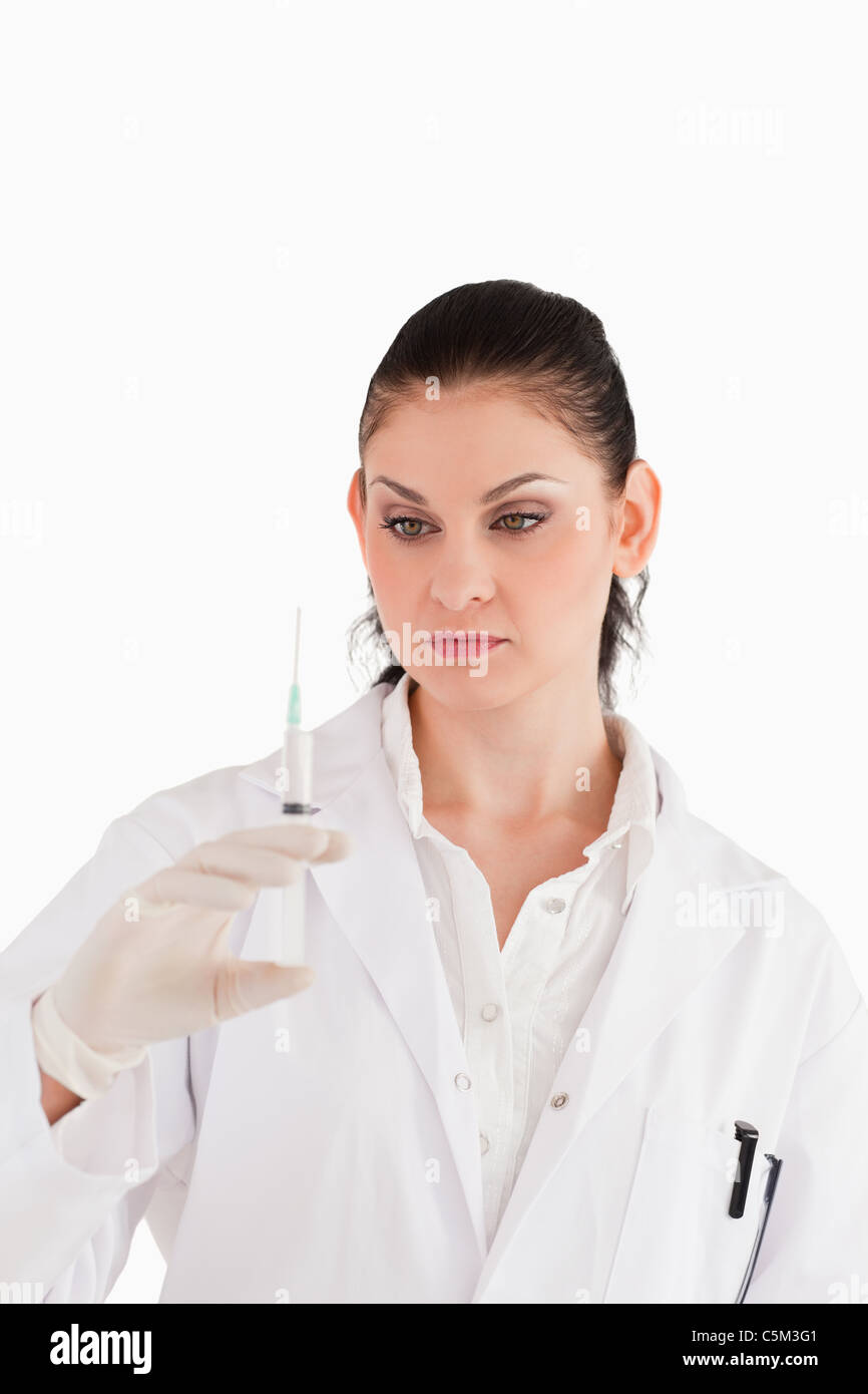Woman in white coat preparing a syringe Stock Photo - Alamy