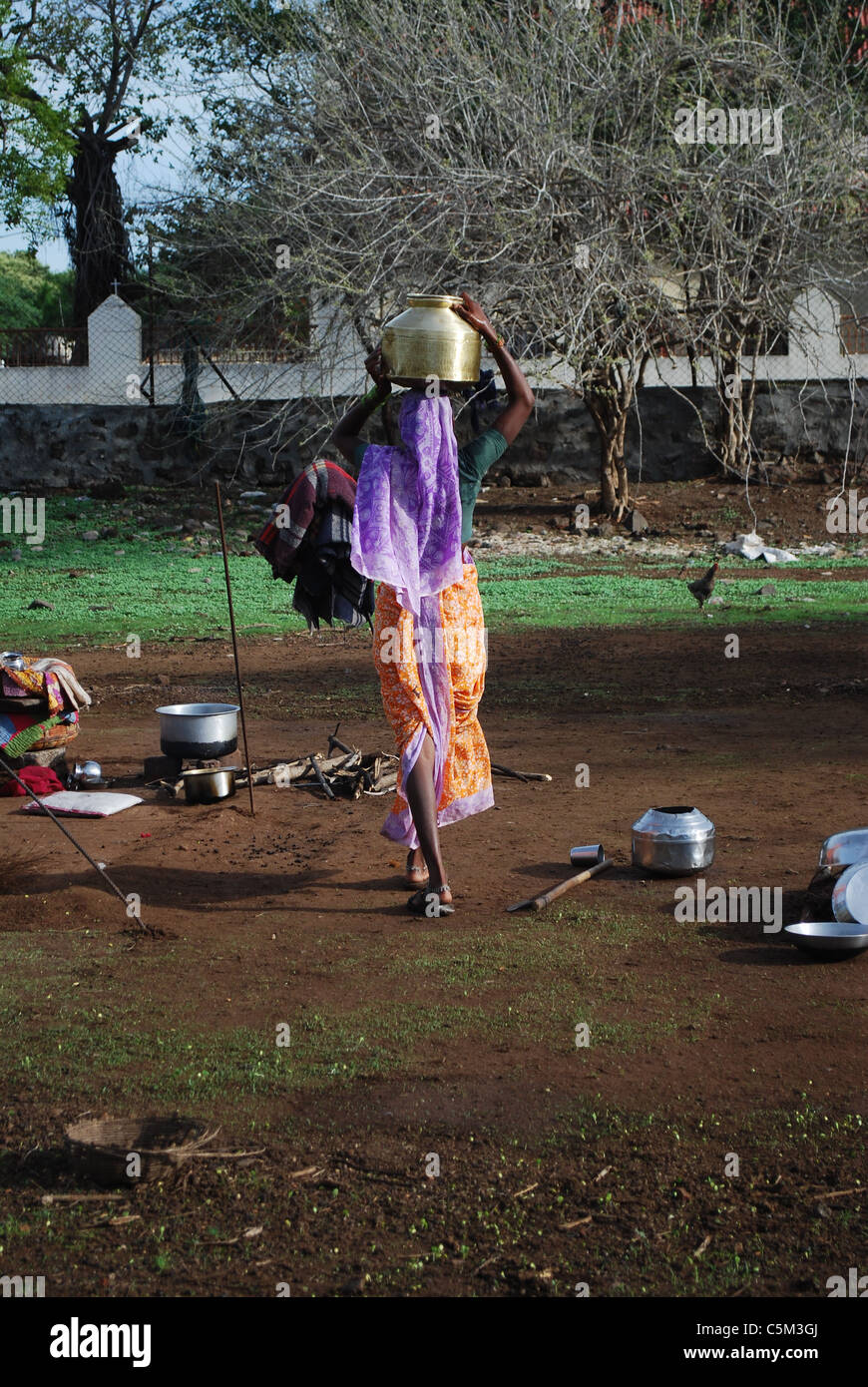 a woman carrying brass pot Stock Photo - Alamy