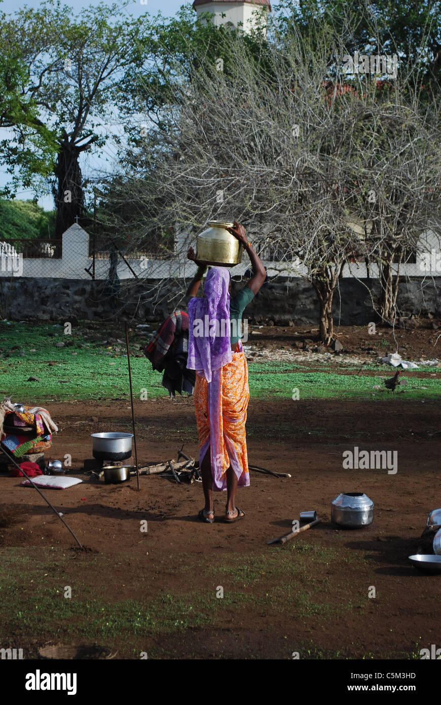 a woman carrying brass pot Stock Photo - Alamy