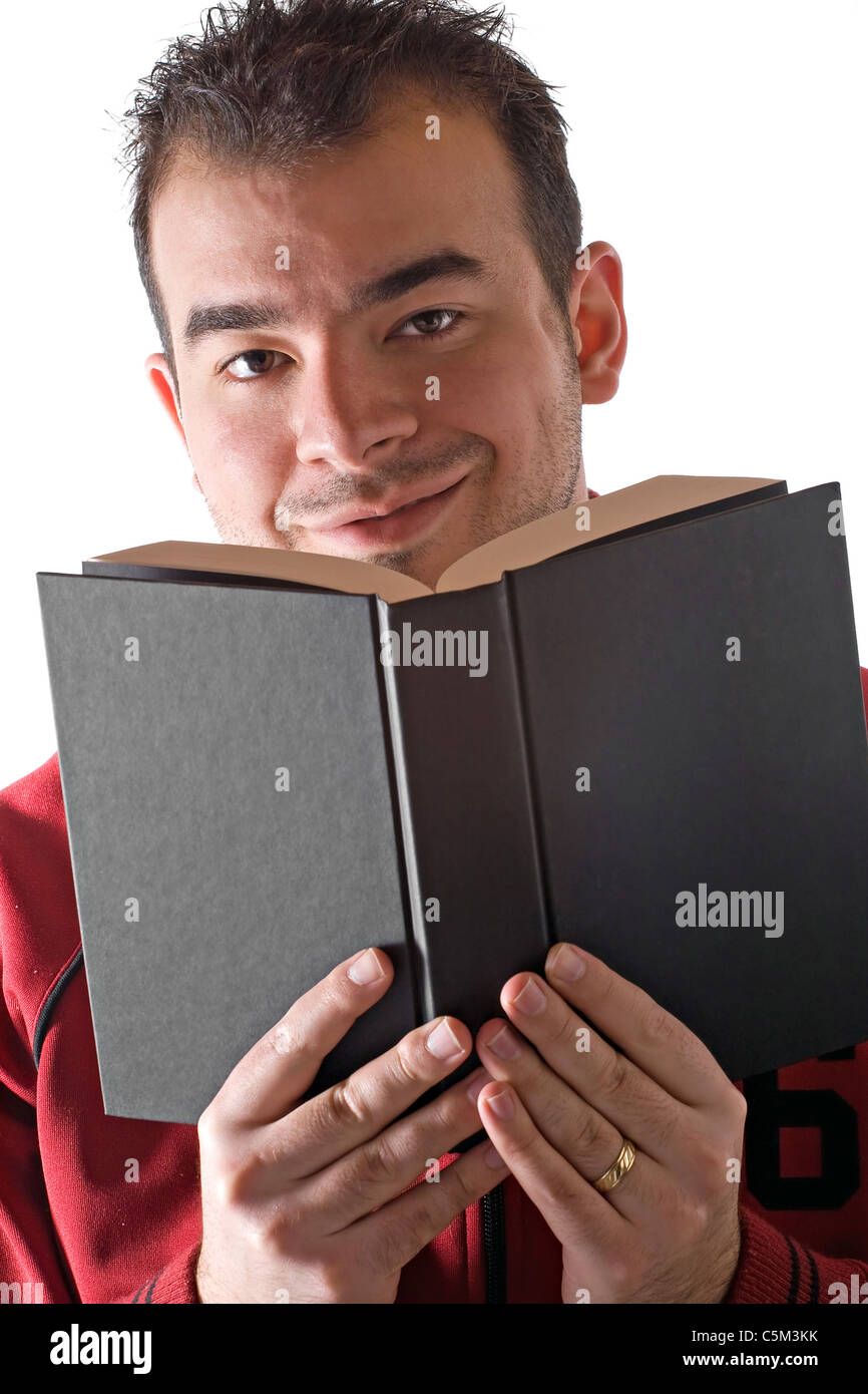 A young man reading a book with a smile on his face Stock Photo - Alamy
