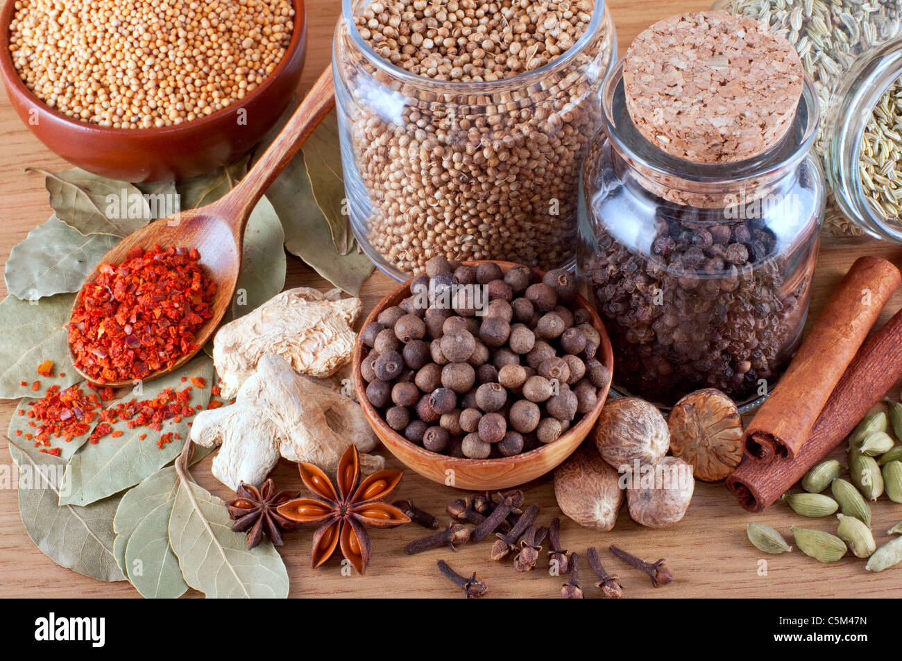 Still life of different spices on wooden background Stock Photo - Alamy