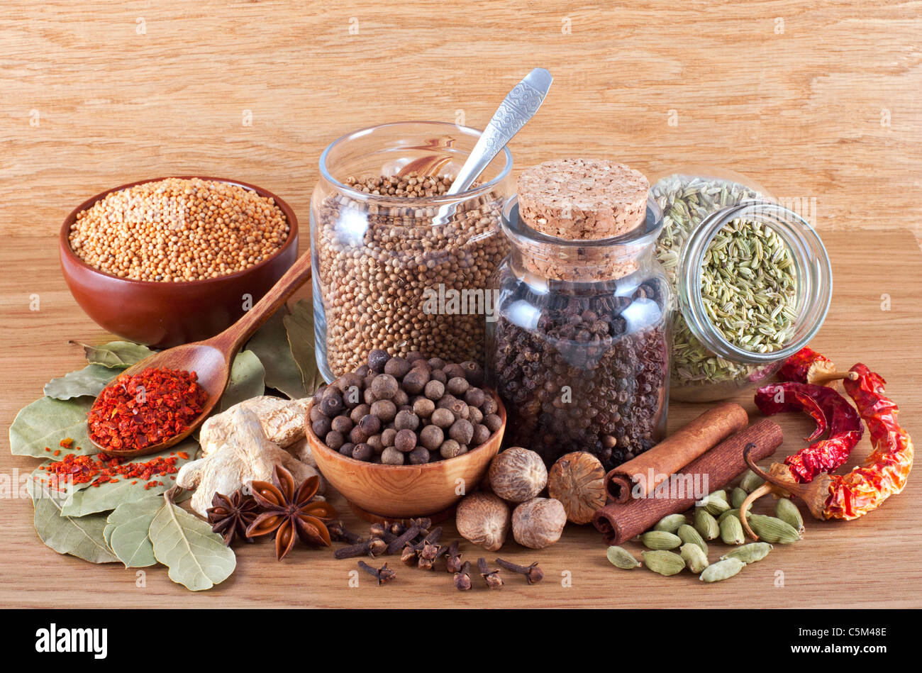 Still life of different spices on wooden background Stock Photo - Alamy