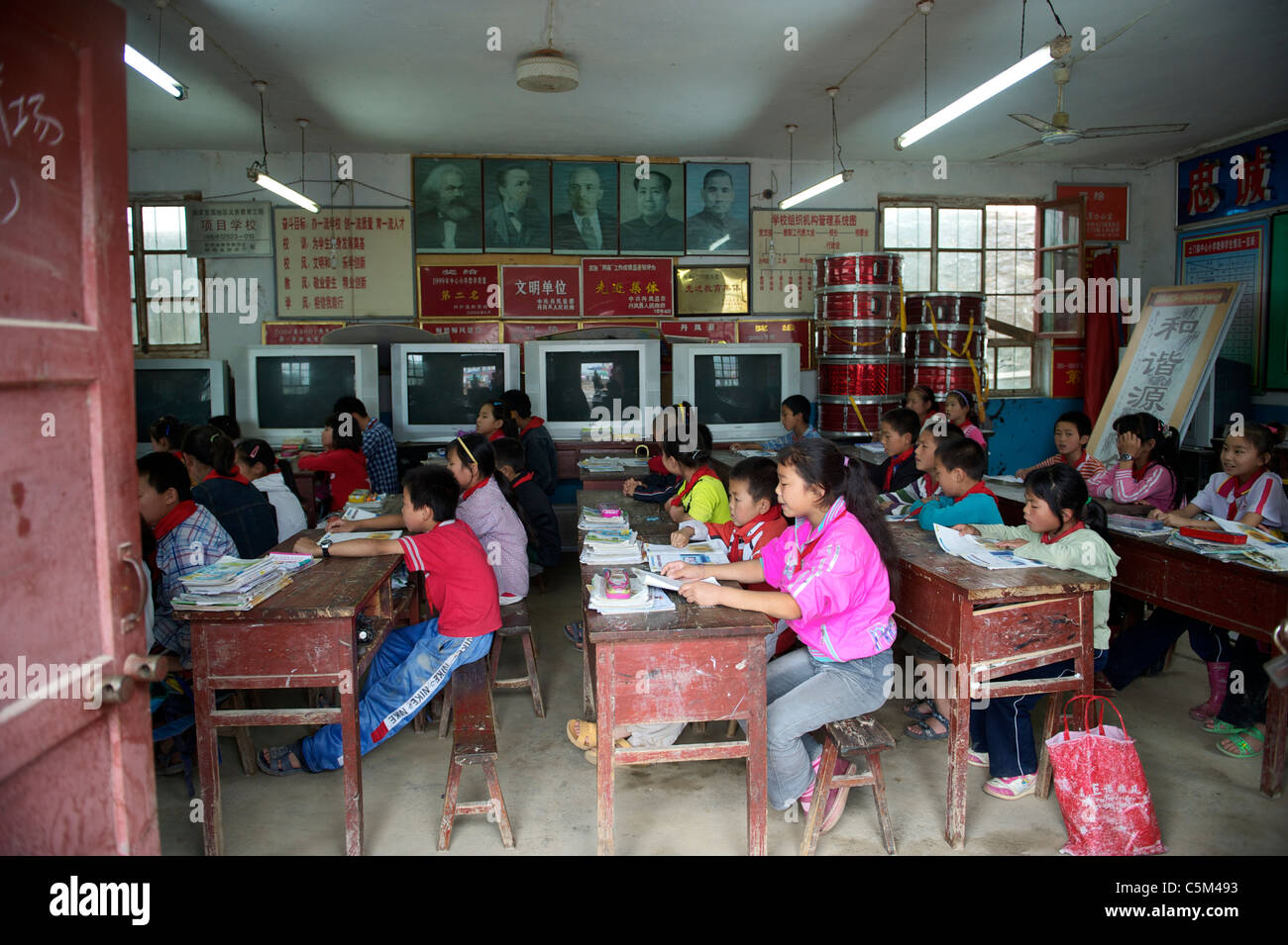 Chinese primary school students attending class at a poor village in ...