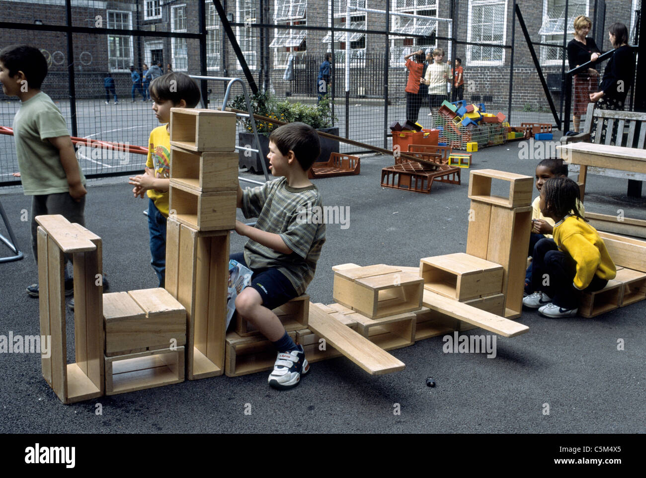 nursery school playground children playing with boxes Stock Photo - Alamy