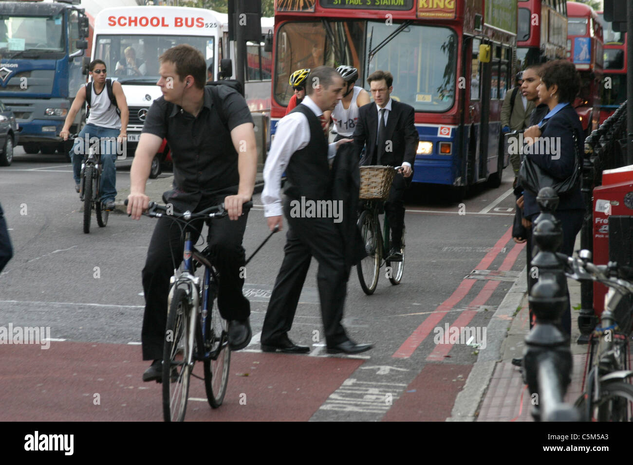 pedestrians cyclists buses and cars on a busy city road Stock Photo - Alamy