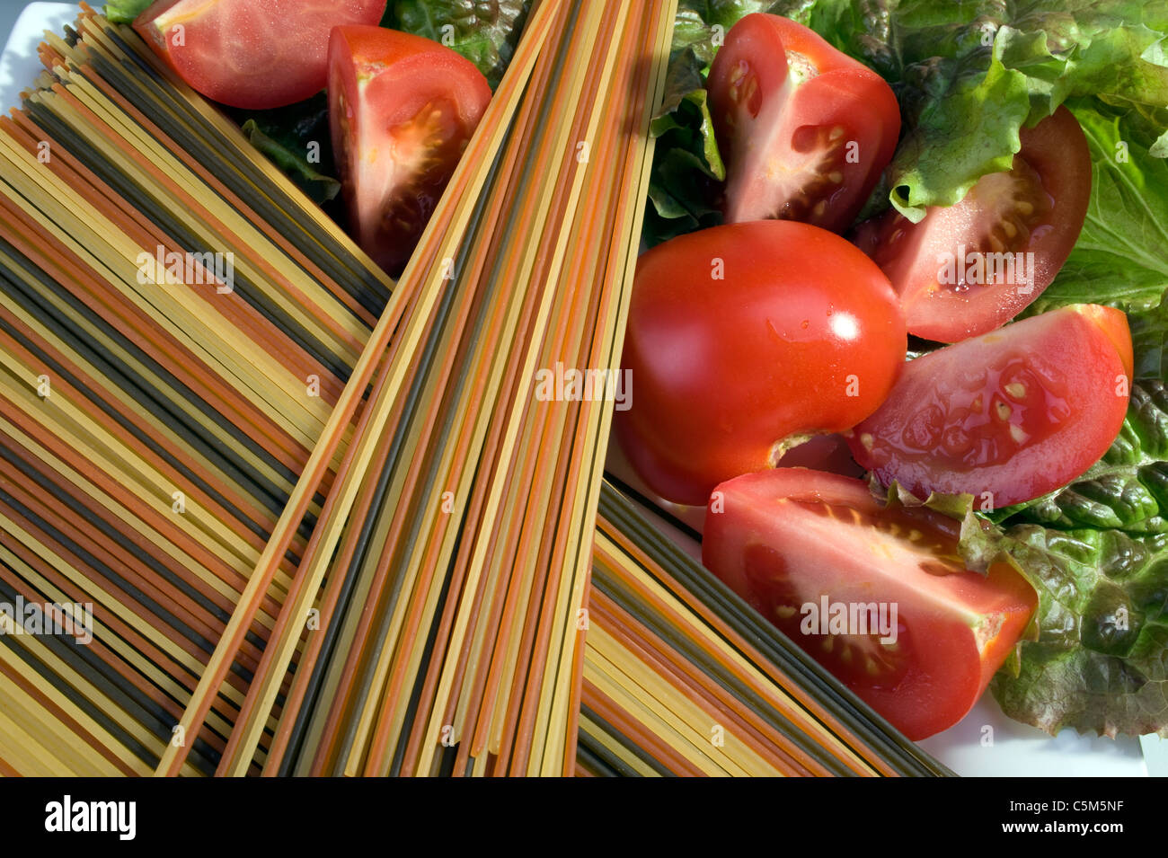 Fancy spaghetti, tomatoes and salad Stock Photo - Alamy