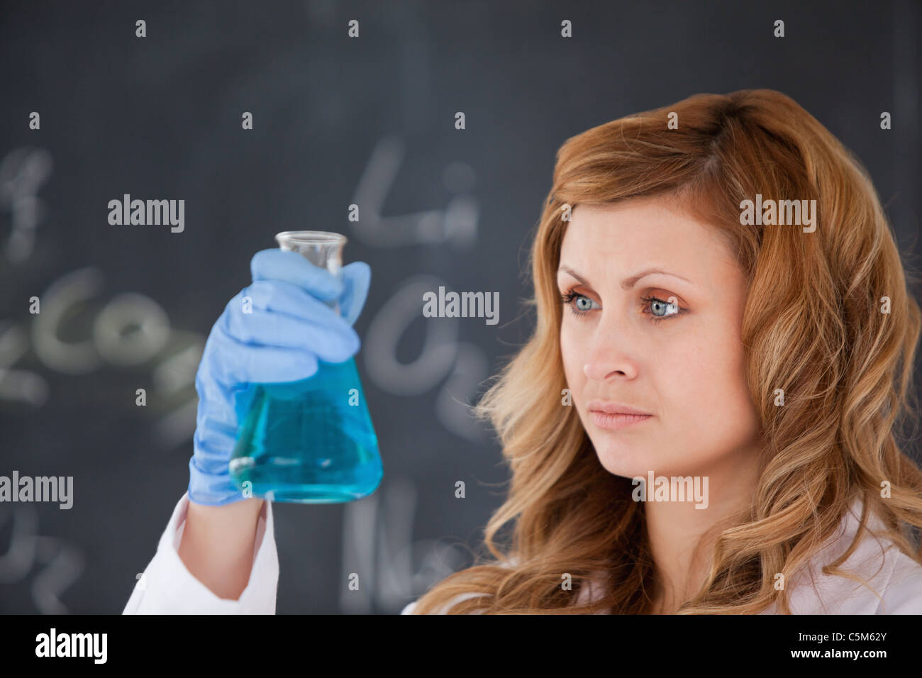 Cute female scientist conducting an experiment Stock Photo - Alamy