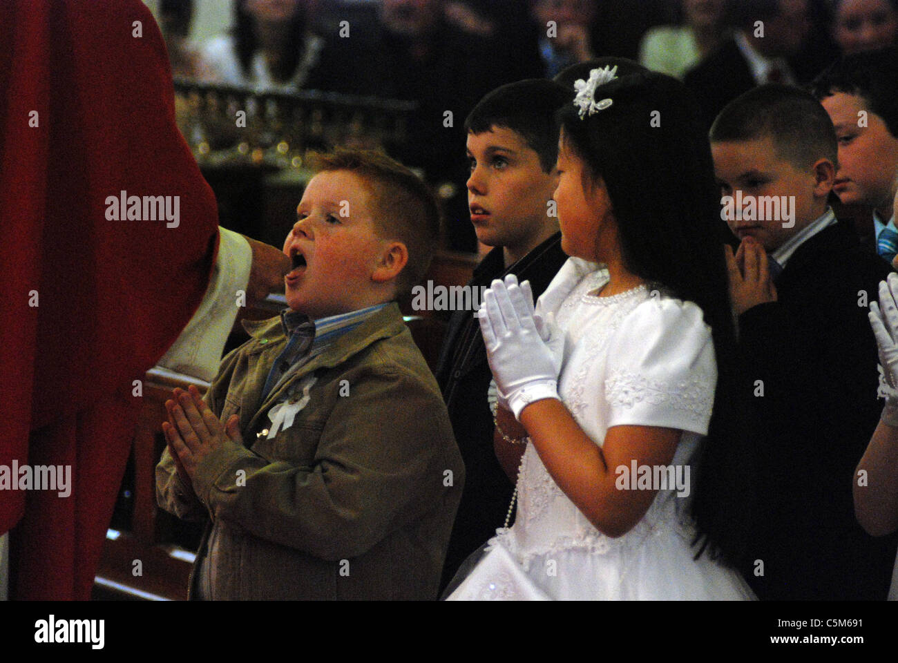Children receive First Communion at a Roman Catholic Church in Ireland ...