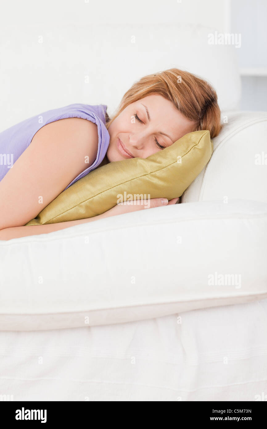 Portrait of an attractive woman taking a rest lying on a sofa Stock ...