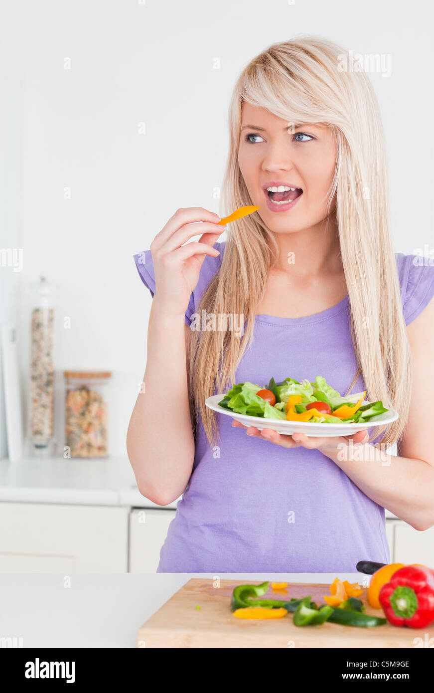 Attractive smiling woman enjoying her salad Stock Photo - Alamy
