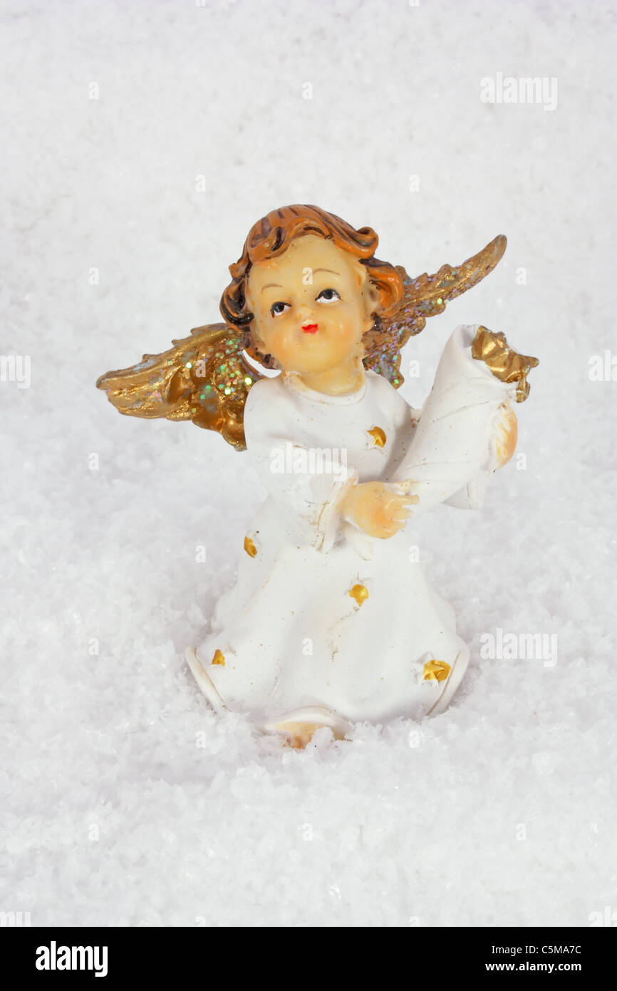 Little angel in artificial snow Christmas decoration Stock Photo - Alamy