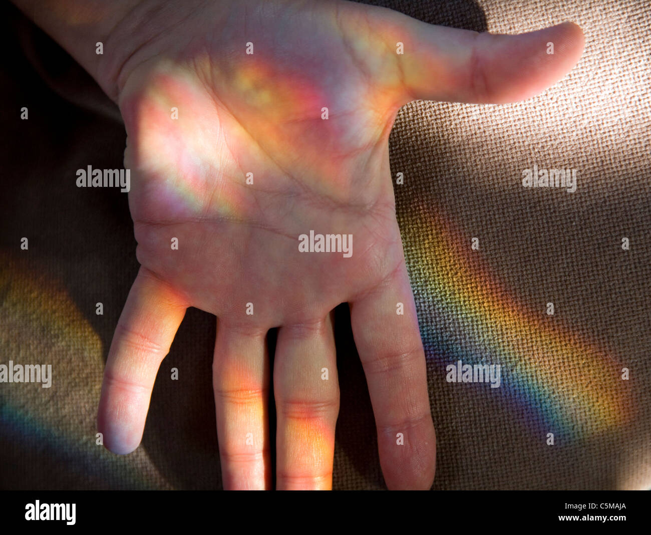 Hand Catching refracted light Stock Photo - Alamy