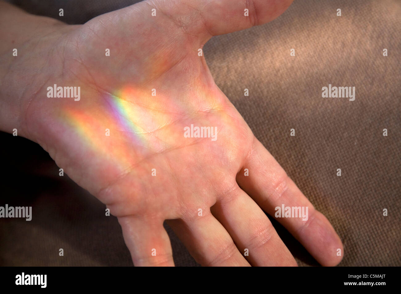 Hand Catching refracted light Stock Photo - Alamy